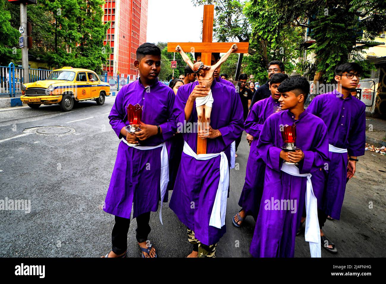 Christian youths and devotees seen carrying a cross as they take part ...