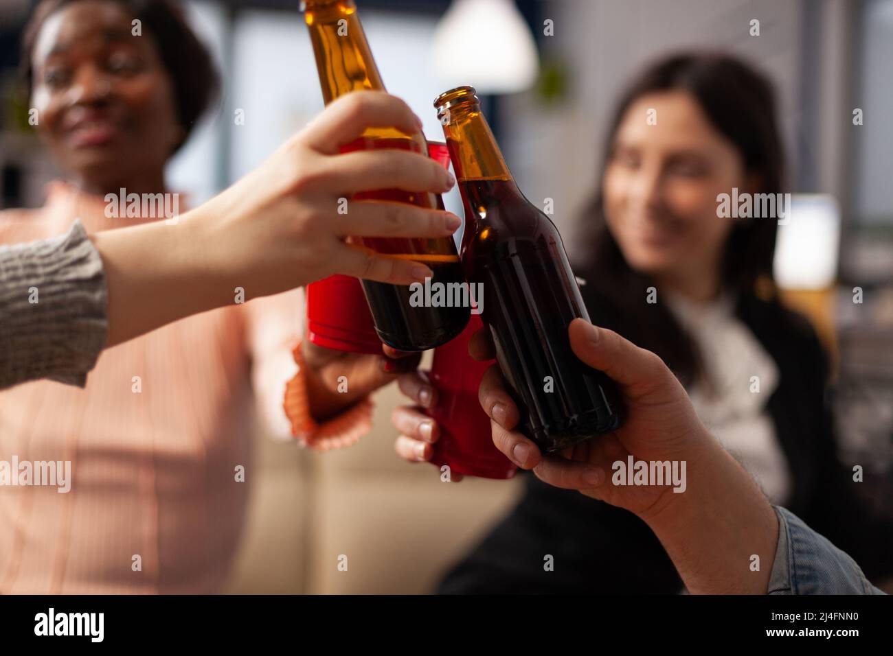 Office colleagues making toast and clinking glasses of alcohol, having ...