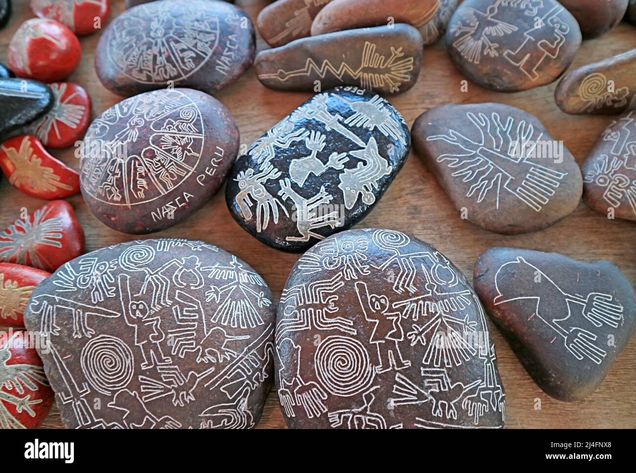 Heap of souvenirs of Nazca lines carved into the various size of pebble ...