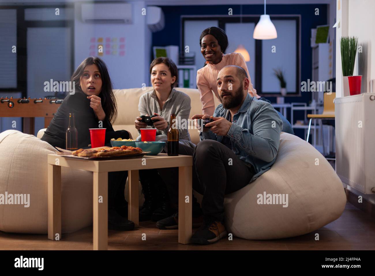 Cheerful coworkers playing video games hi-res stock photography and ...