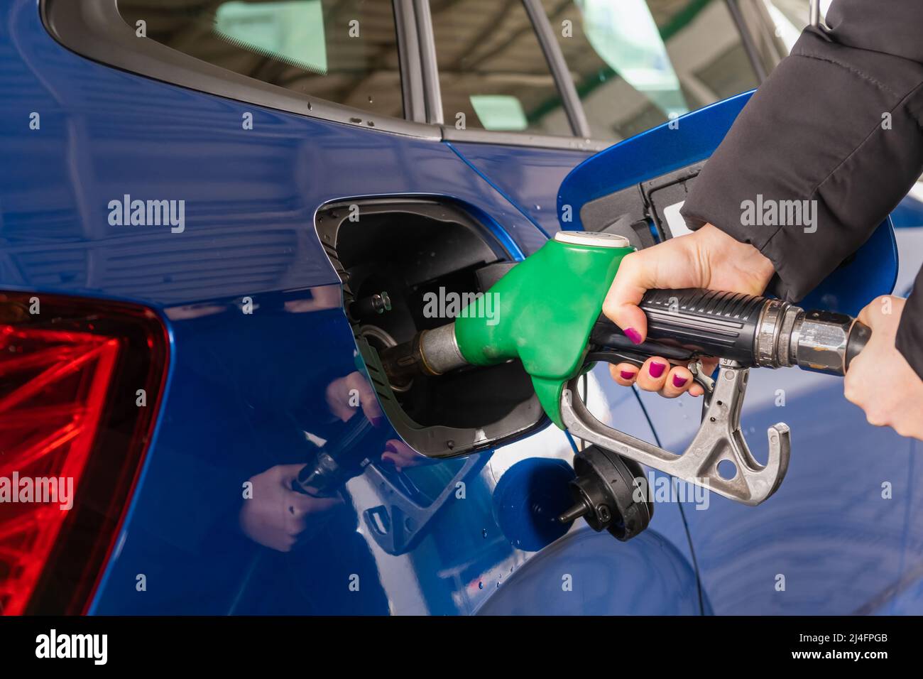 Woman refueling her car hi-res stock photography and images - Alamy