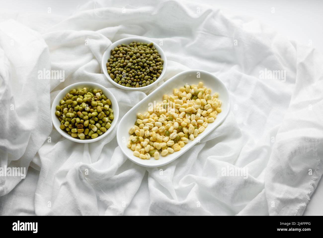 Green mung beans in a bowl on a dark concrete table. Legume plant for a ...