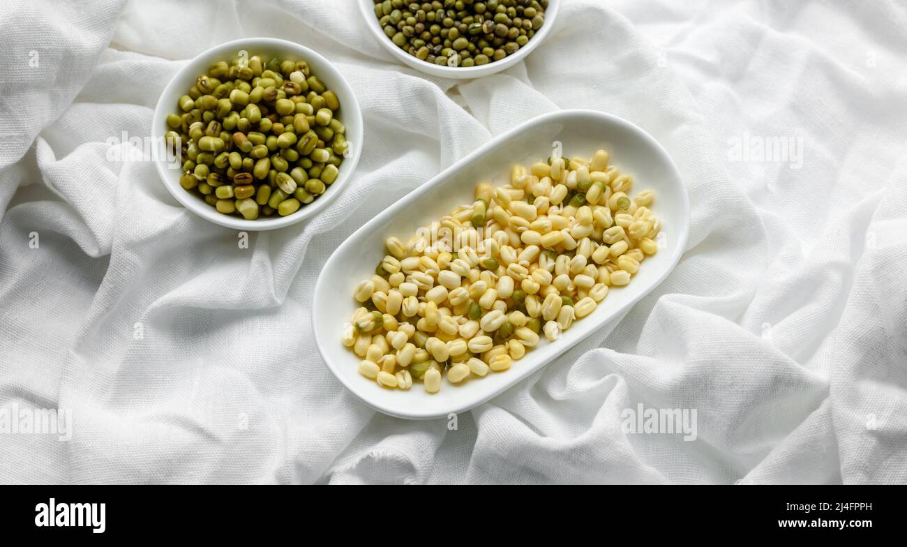 Green mung beans in a bowl on a dark concrete table. Legume plant for a ...