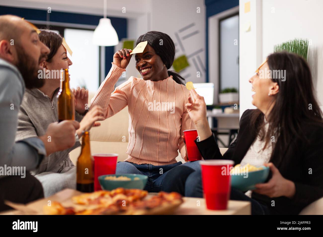 African american woman playing guess who game with coworkers ...