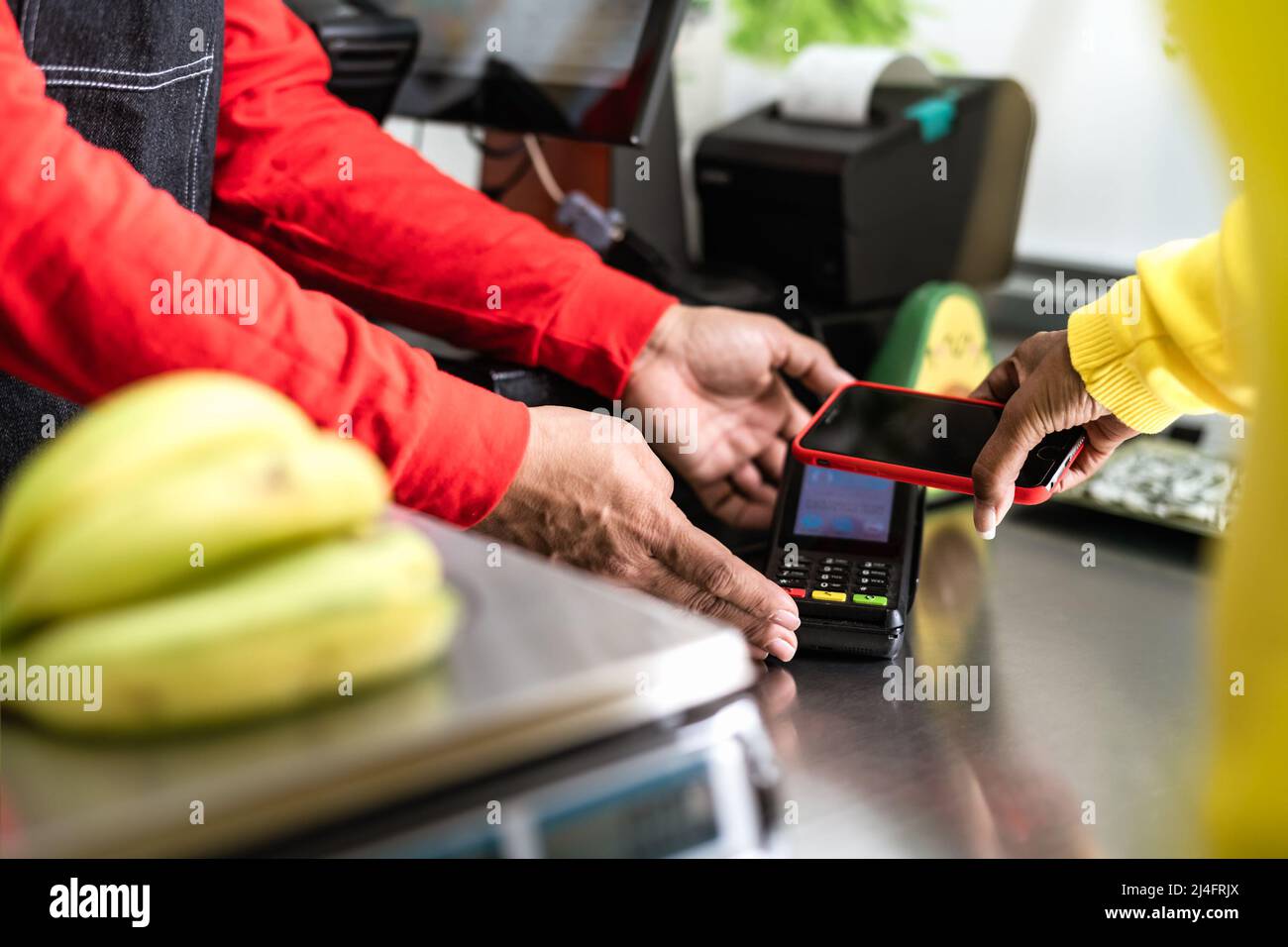 Close up customer making a payment with mobile smartphone inside ...