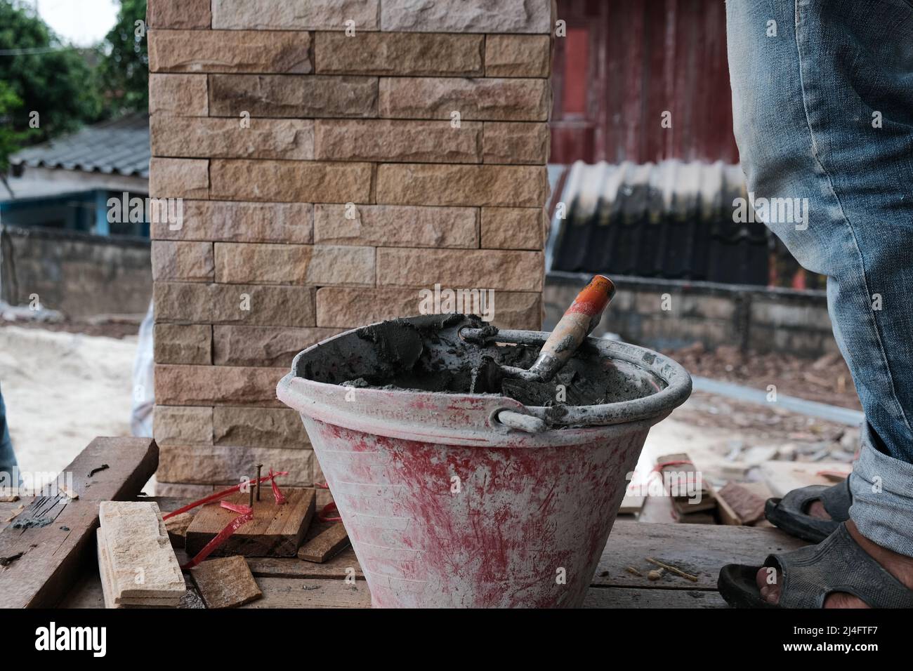 Man working stone tile on new house pole interior building Stock Photo ...