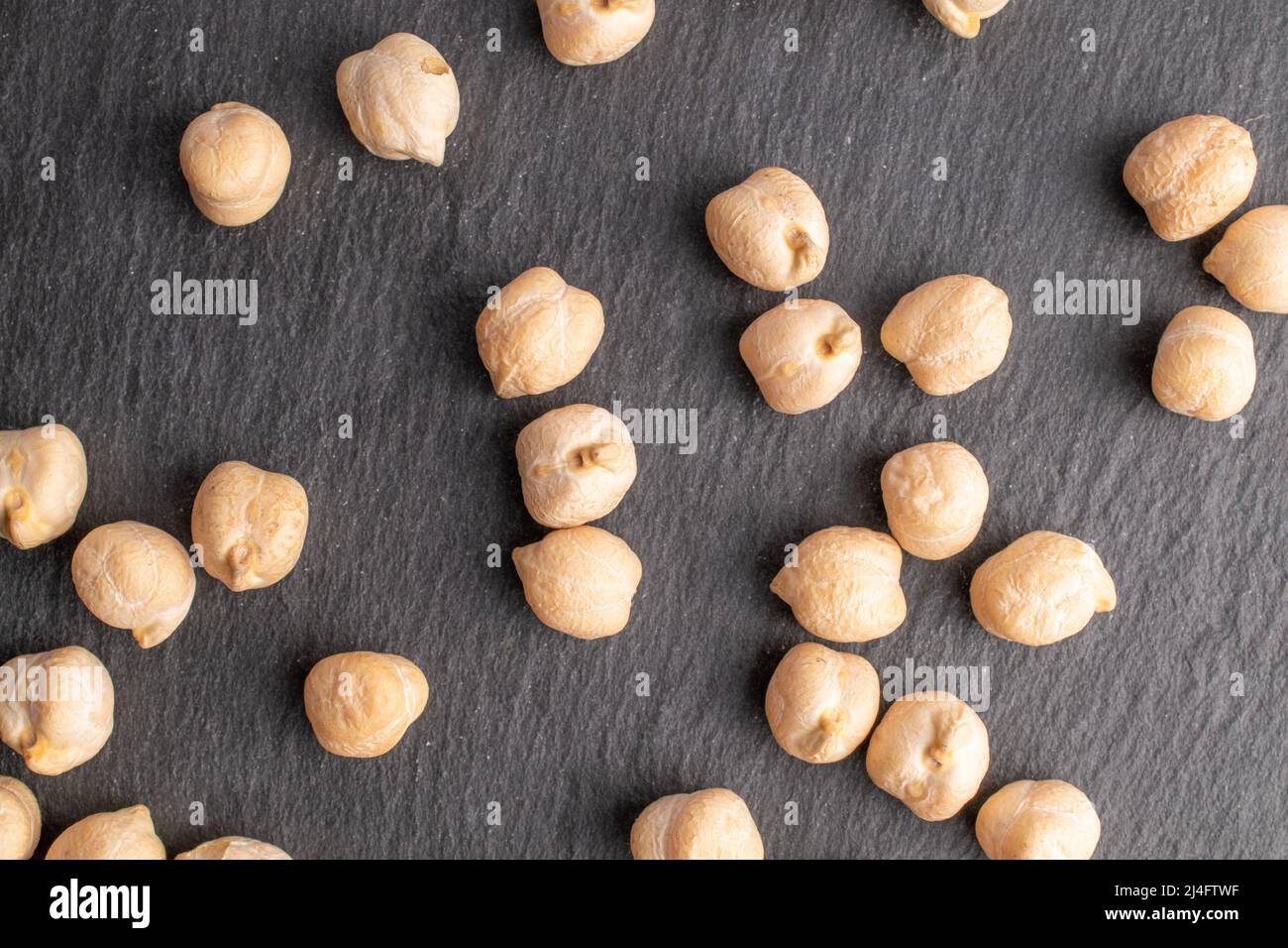 Organic uncooked chickpeas, close-up, on a slate board, top view Stock ...