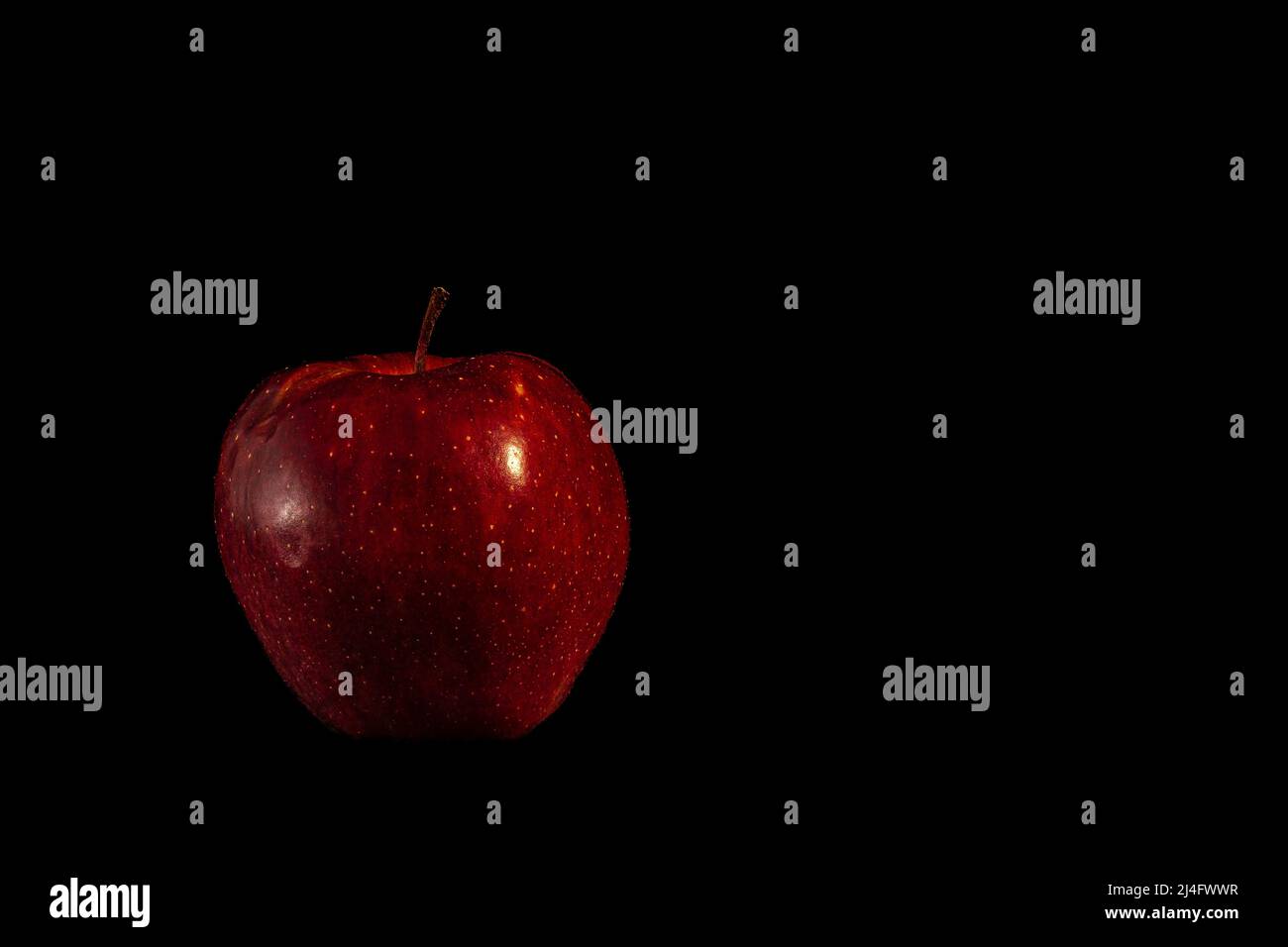 a red apple on a black background, ideal for wallpapers Stock Photo - Alamy