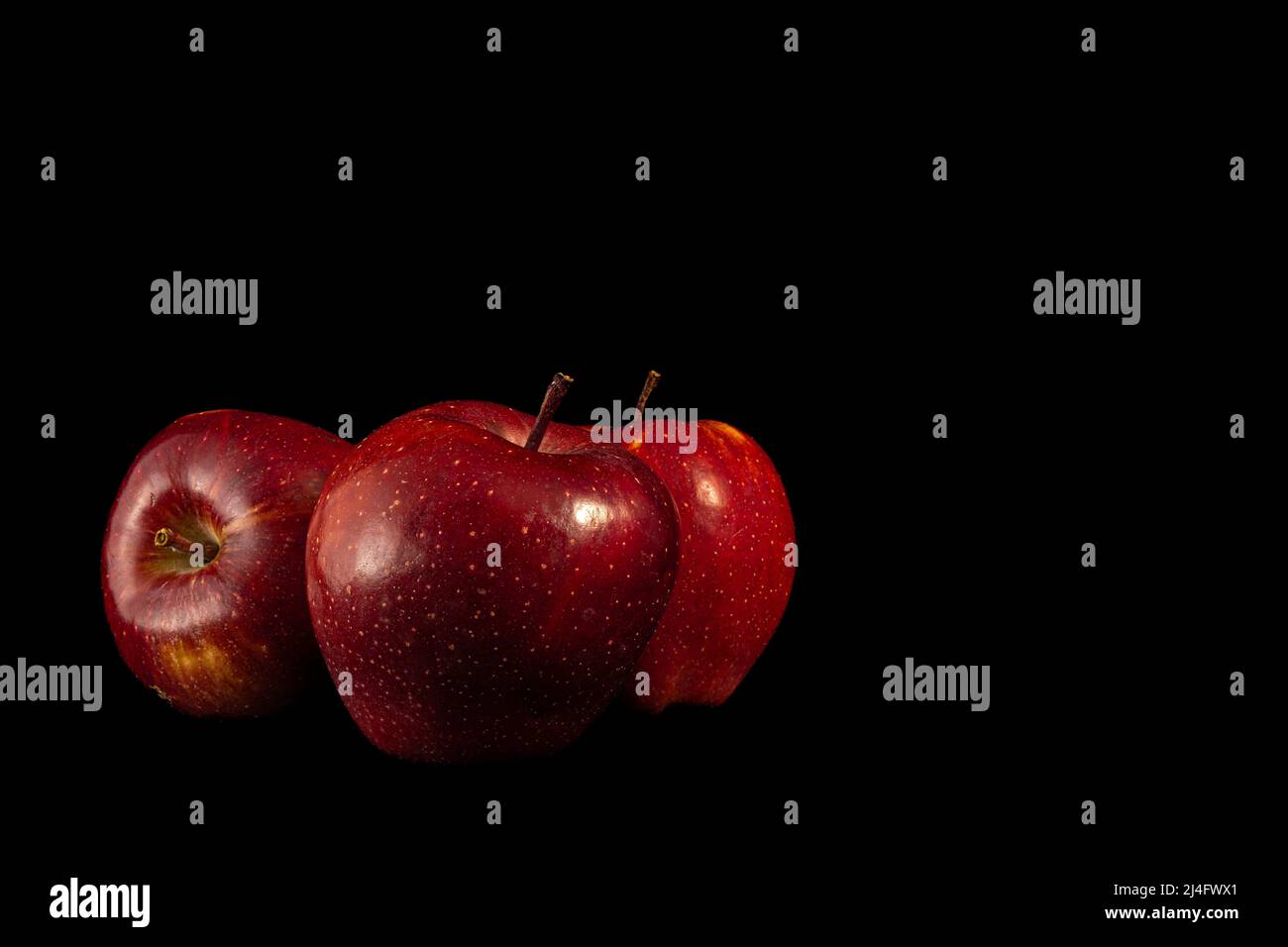 Three red apples on a black background, ideal for wallpapers Stock ...