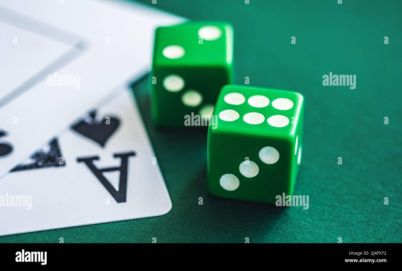 Green dice and playing cards Stock Photo - Alamy