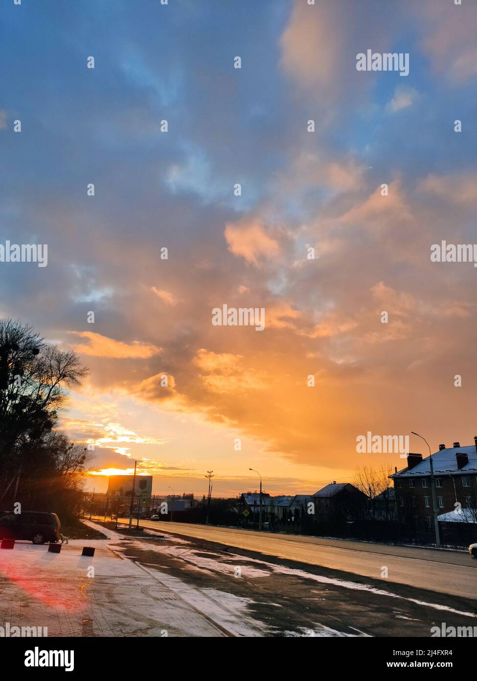 a beautiful orange sunset on city road with cars Stock Photo - Alamy