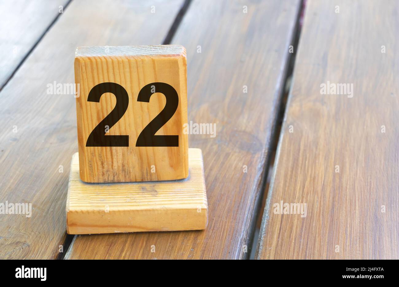 Wooden priority number 22 on a plank tab Stock Photo - Alamy