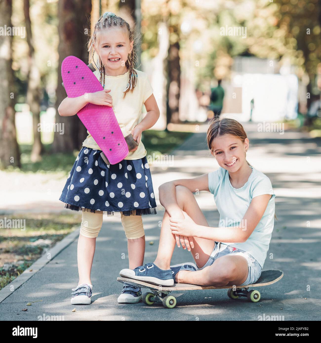 Girls with skateboards in the park Stock Photo - Alamy