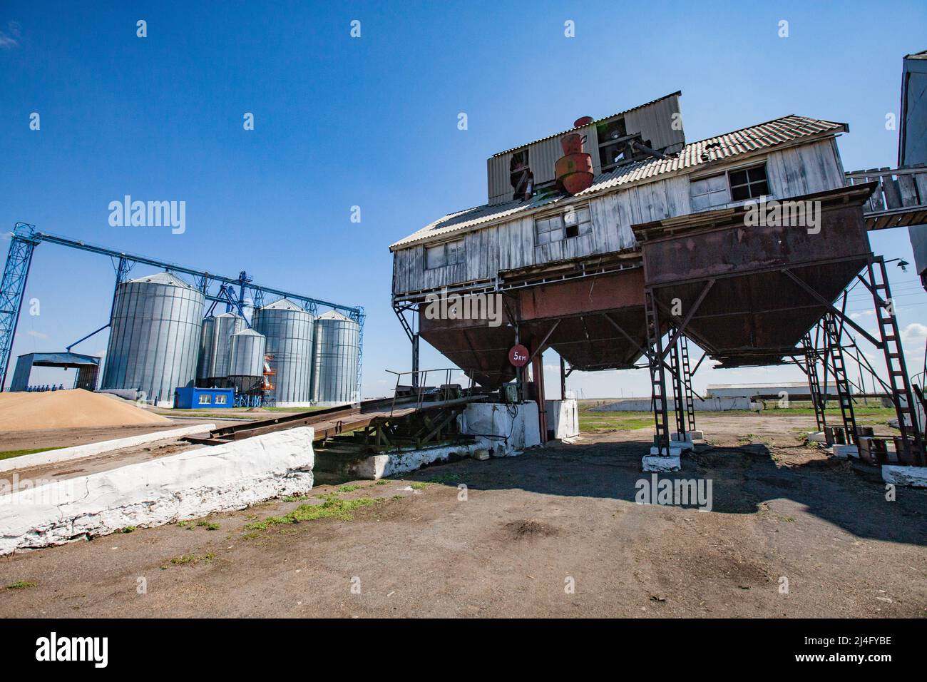 Old outdated Soviet grain storage (right) and modern steel elevator ...