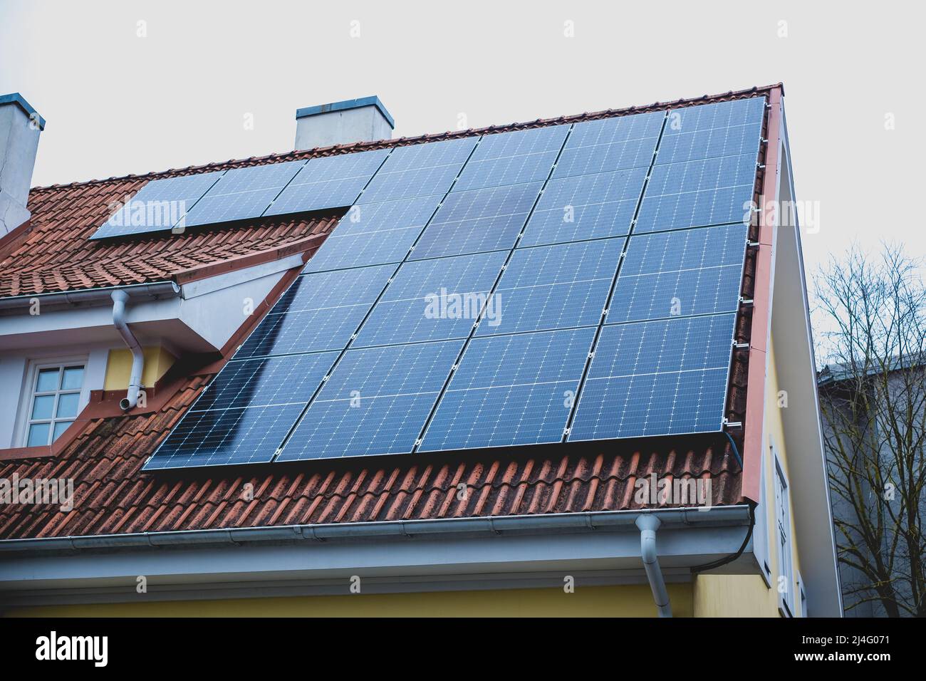 Close-up of solar panels installed on historic building gable roof with ...