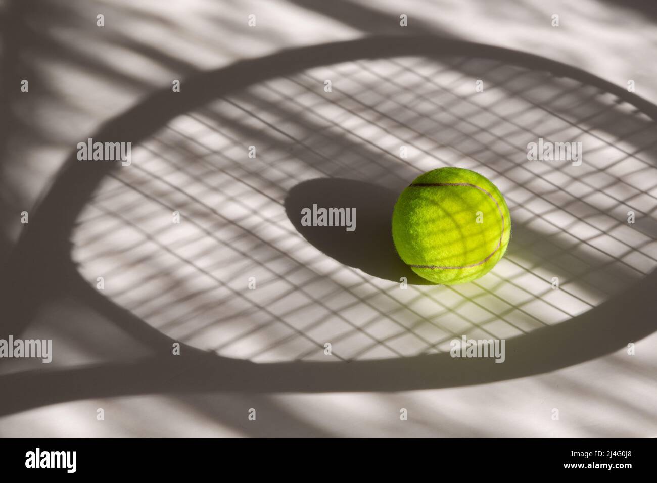 Tennis ball and its shadow on an isolated white background. Ball in ...