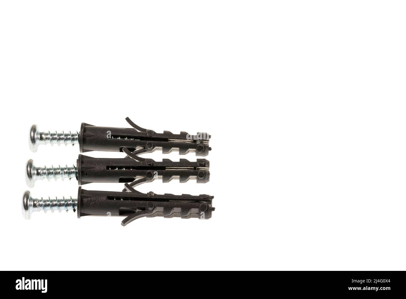 Close up view of screws screwed into black plastic screw caps isolated ...