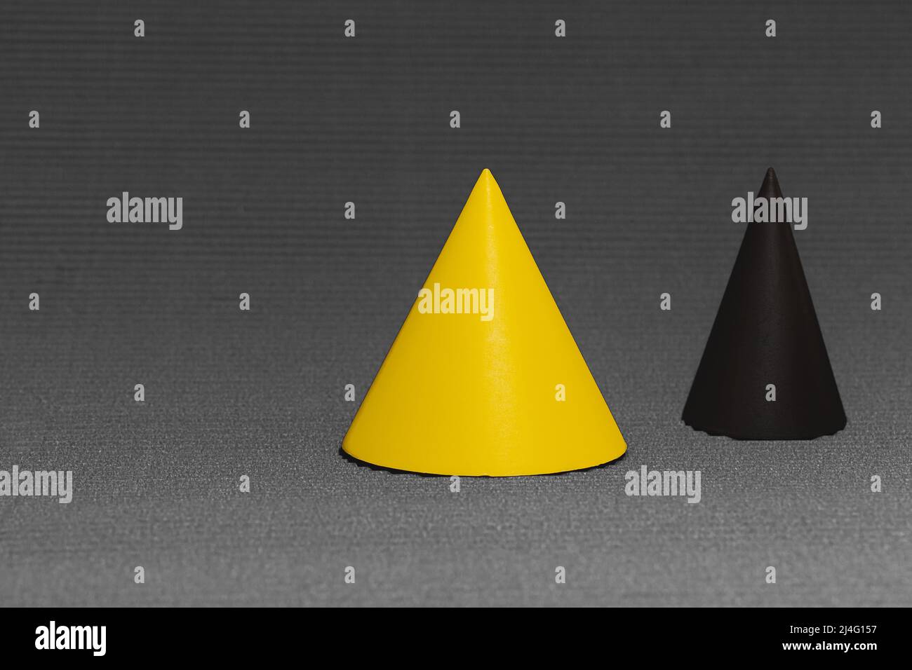 Yellow and black conical geometric shapes on serrated background in ...