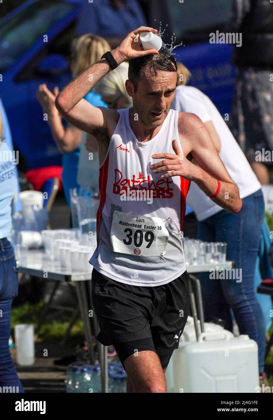 A runner cools himself down during the Maidenhead Easter 10K race in ...