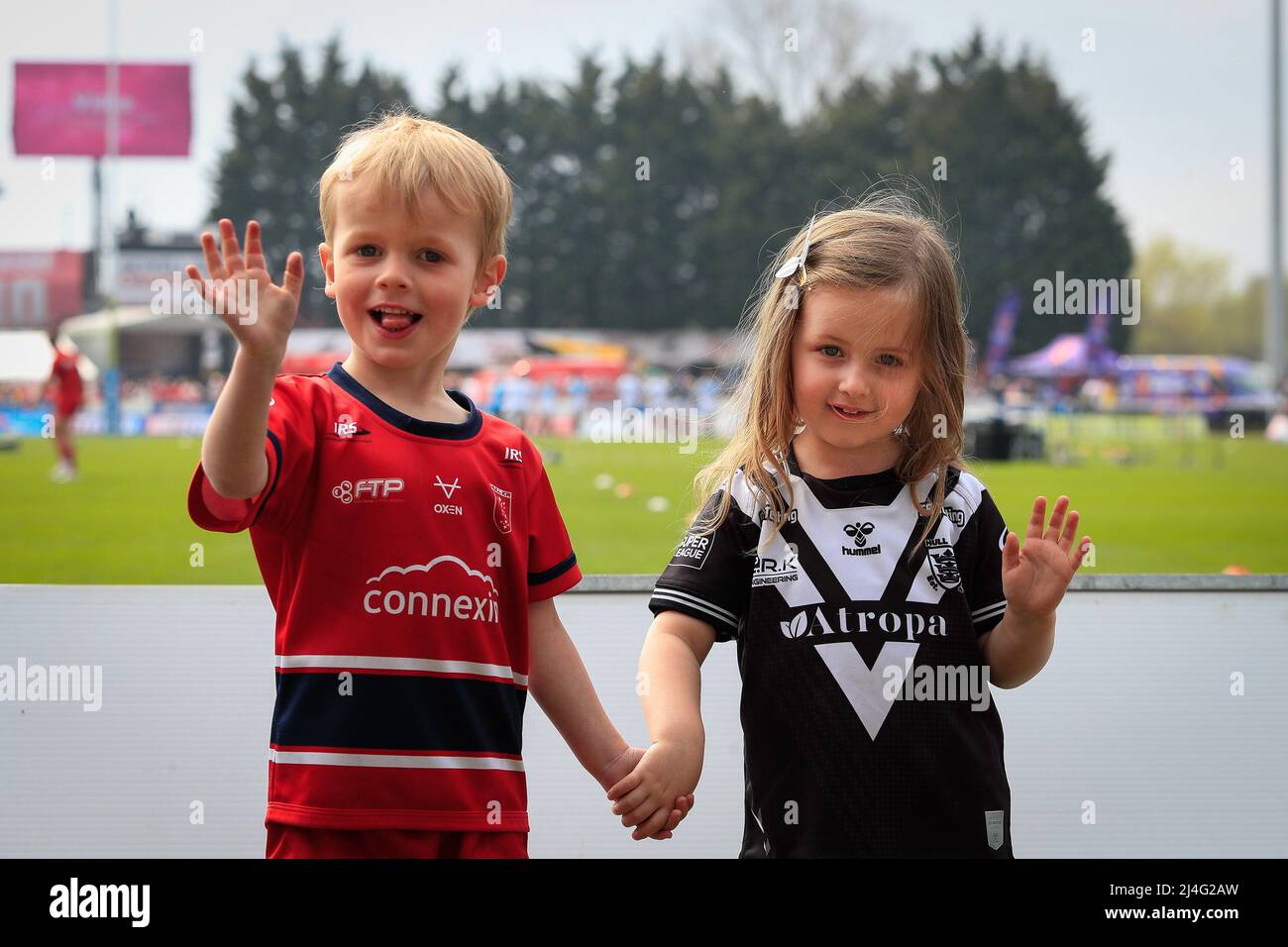 Two young opposing supporters of Hull KR and Hull FC hold hands and ...