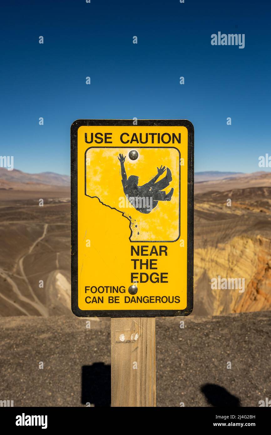 Use Caution Near The Edge Sign at Ubehehe Crater Stock Photo - Alamy