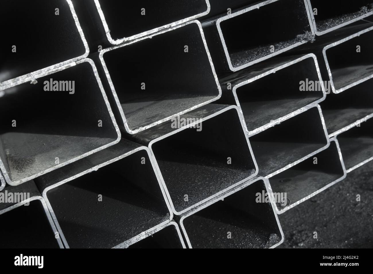 Abstract metallurgy background, rolled metal products, steel pipes with ...