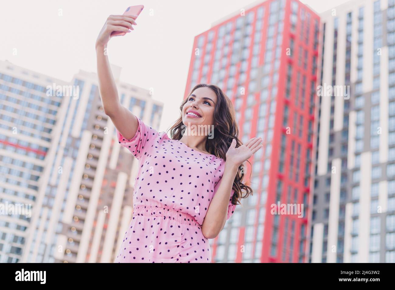Portrait of attractive cheerful girl using device taking selfie waving ...