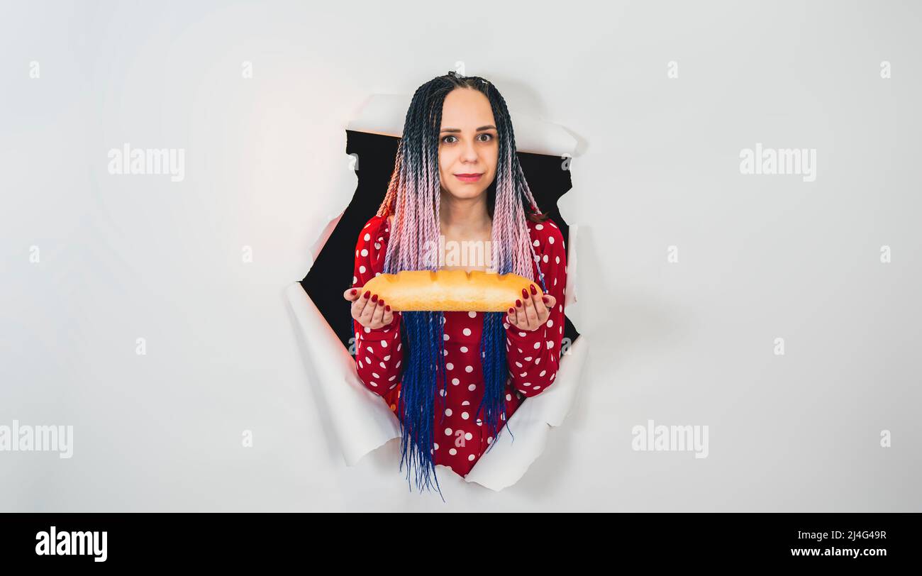 Female in a red dress with loaf in hole of white background Stock Photo ...