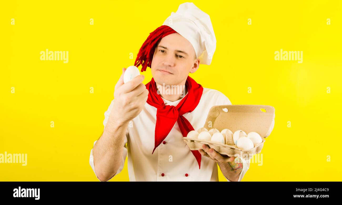 Man with red dreadlocks holds it in his hand chicken eggs. Confident ...