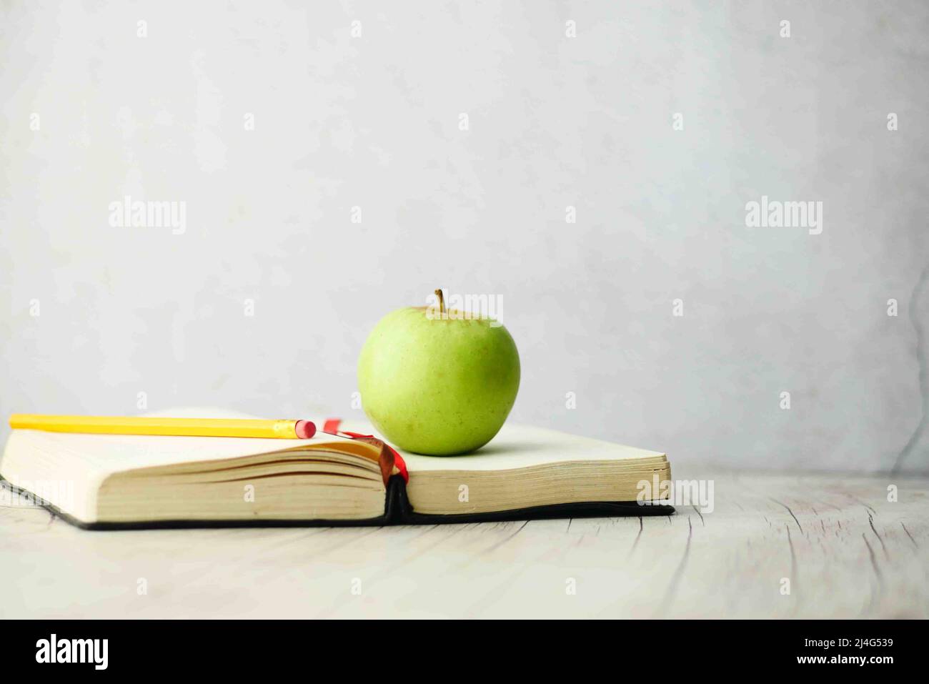 black to school concept with apple on notepad on table Stock Photo - Alamy