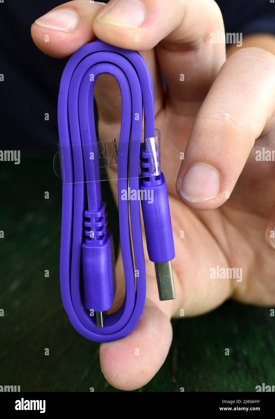 hand holding new usb 3 purple cable,image of a Stock Photo - Alamy