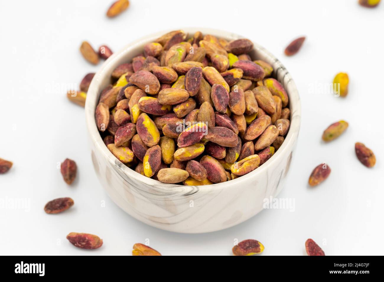 Pistachio kernel isolated on white background. A bowl of pistachios ...