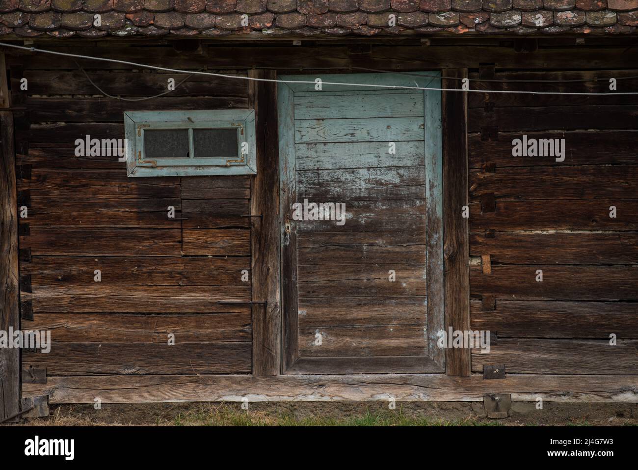 Old wooden rustic doors on rural home wall Stock Photo - Alamy
