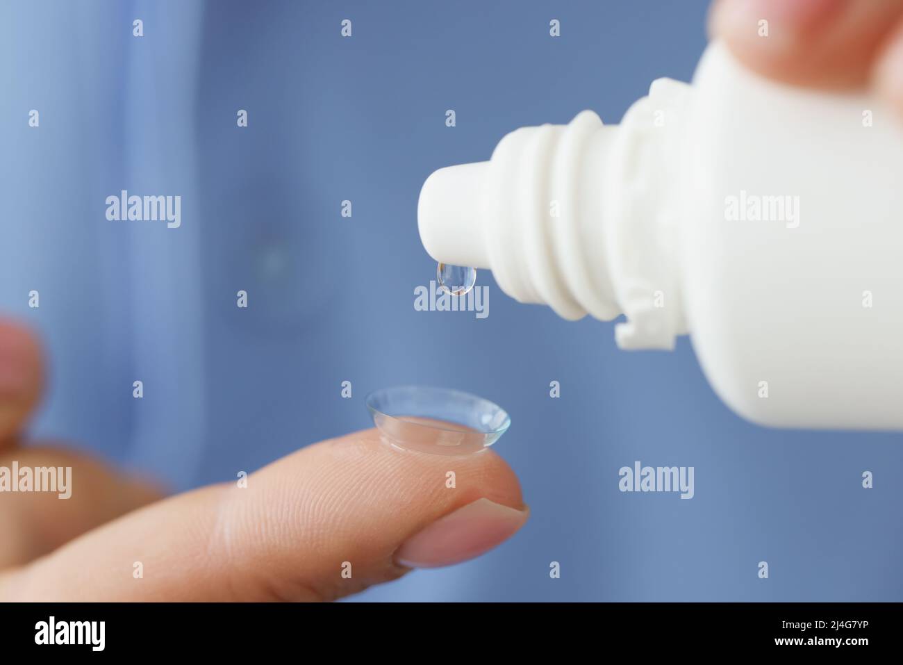 Drop of medical solution on soft contact lens. Eye lens care concept ...