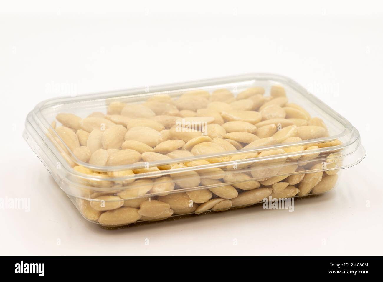 Packed peeled raw almonds on a white background. Peeled raw almonds ...
