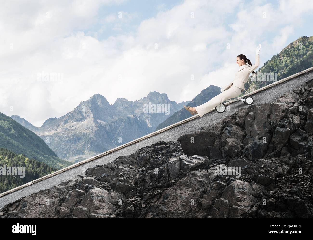 Beautiful happy woman riding downhill Stock Photo - Alamy