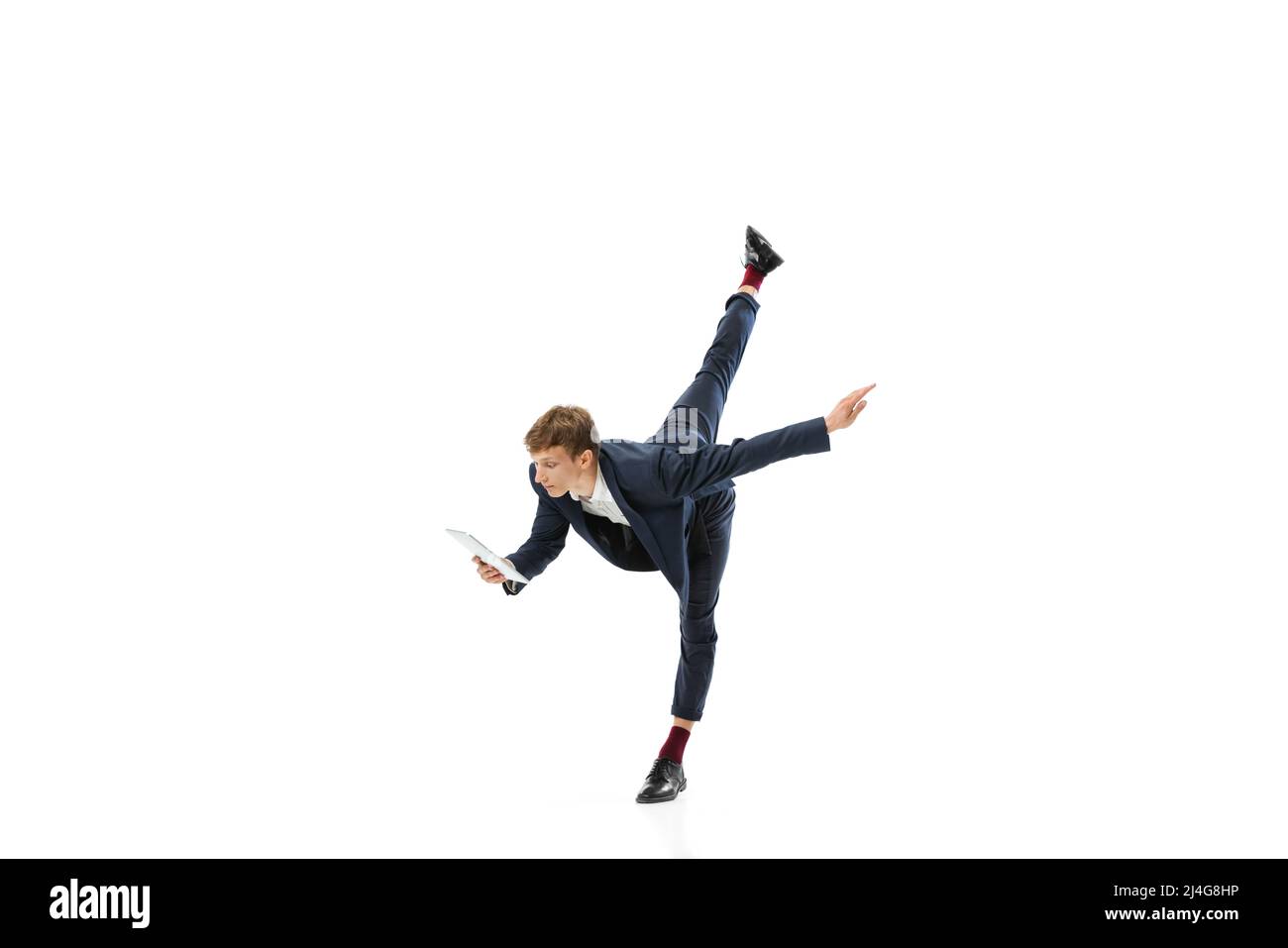 Man in office style clothes dancing and using tablet isolated on white ...