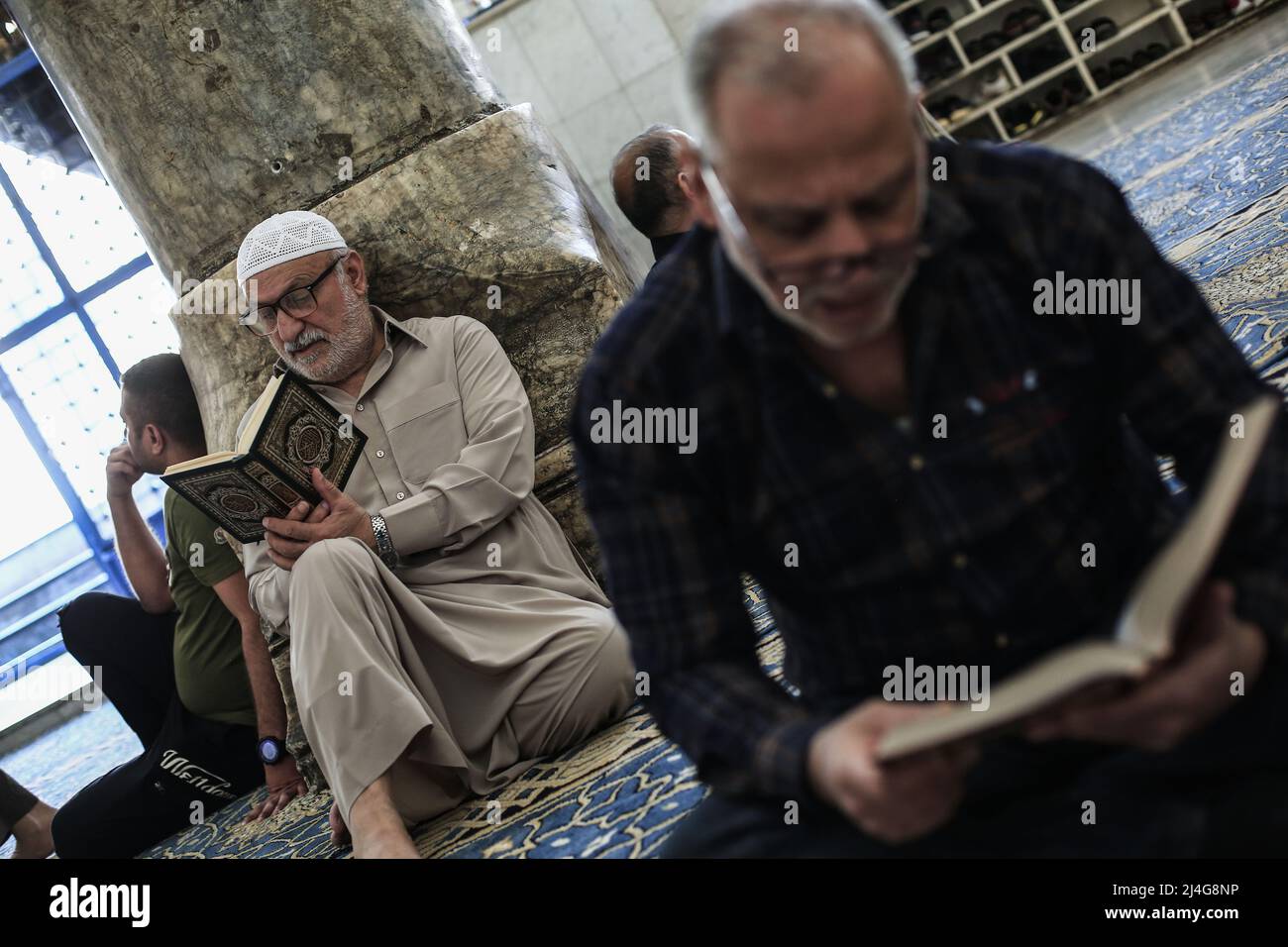 Baghdad, Iraq. 15th Apr, 2022. Iraqi men read Quran in Sheikh Abdul ...