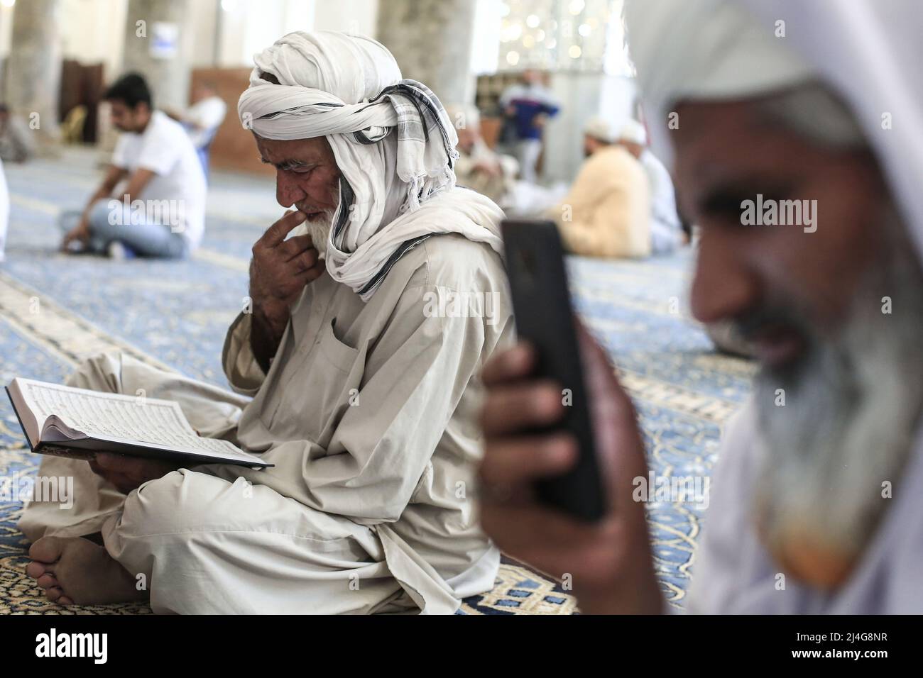 Baghdad, Iraq. 15th Apr, 2022. Iraqi men read Quran in Sheikh Abdul ...