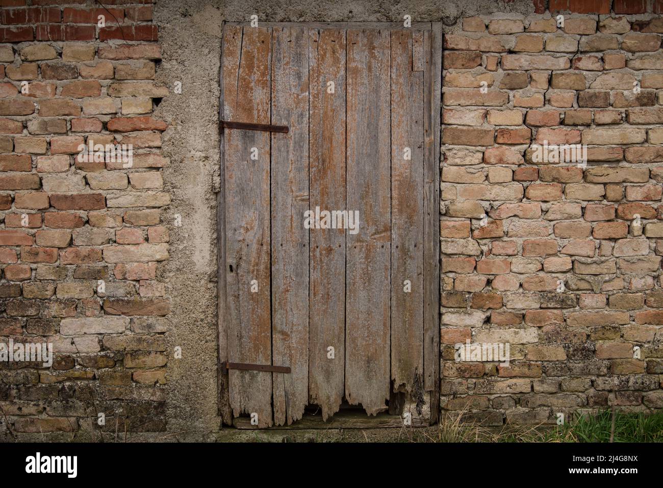Old wooden rustic doors on rural home wall Stock Photo - Alamy