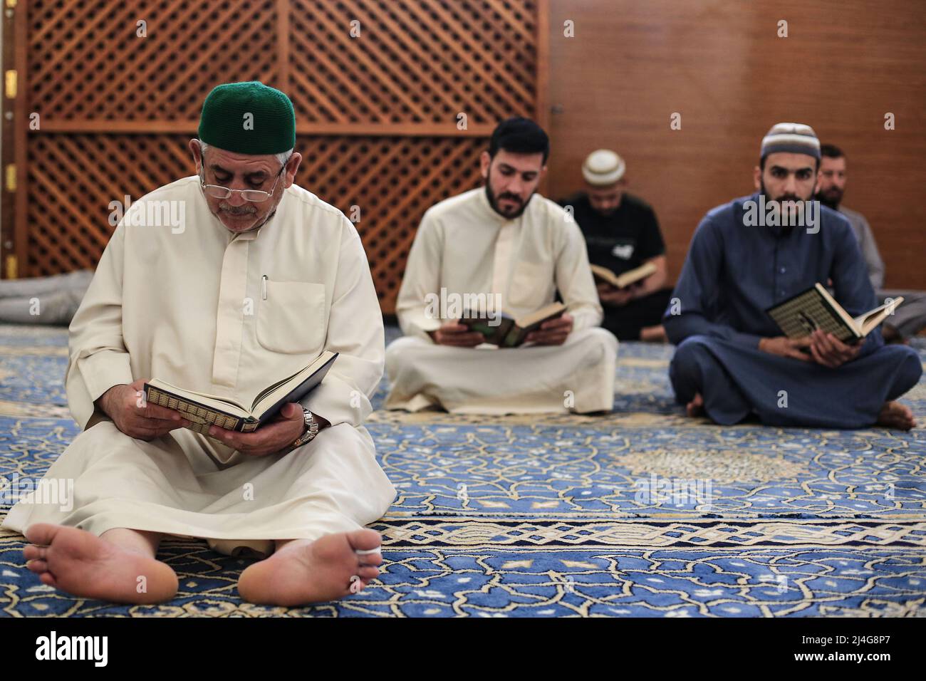 Baghdad, Iraq. 15th Apr, 2022. Iraqi men read Quran in Sheikh Abdul ...
