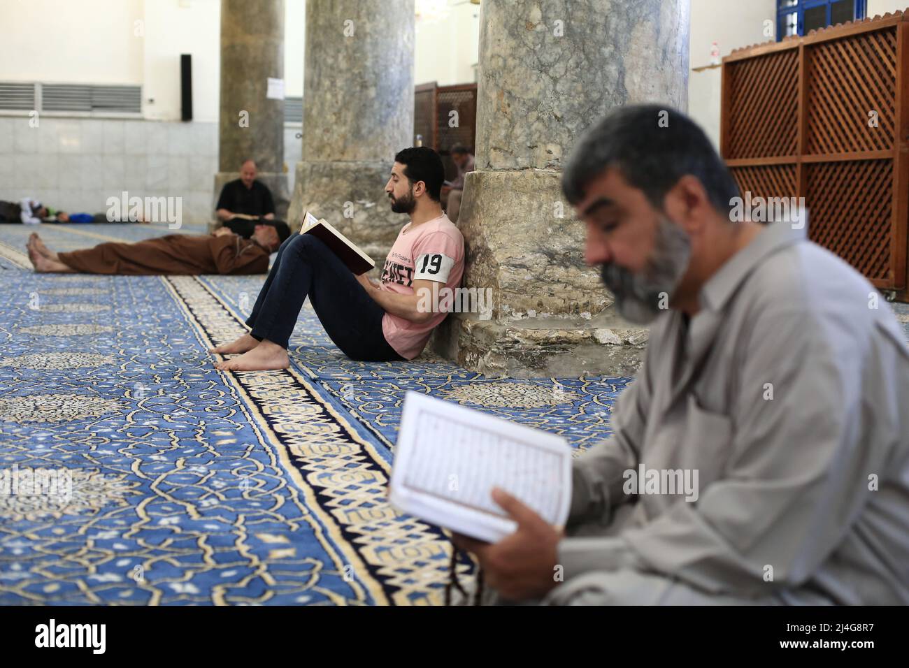 Baghdad, Iraq. 15th Apr, 2022. Iraqi men read Quran in Sheikh Abdul ...