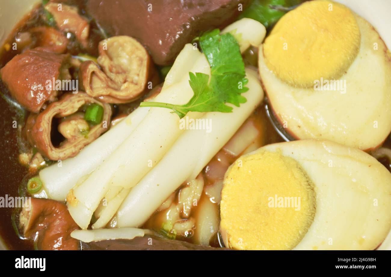 Chinese rice flour paste with pork and entrails topping egg yolk in ...