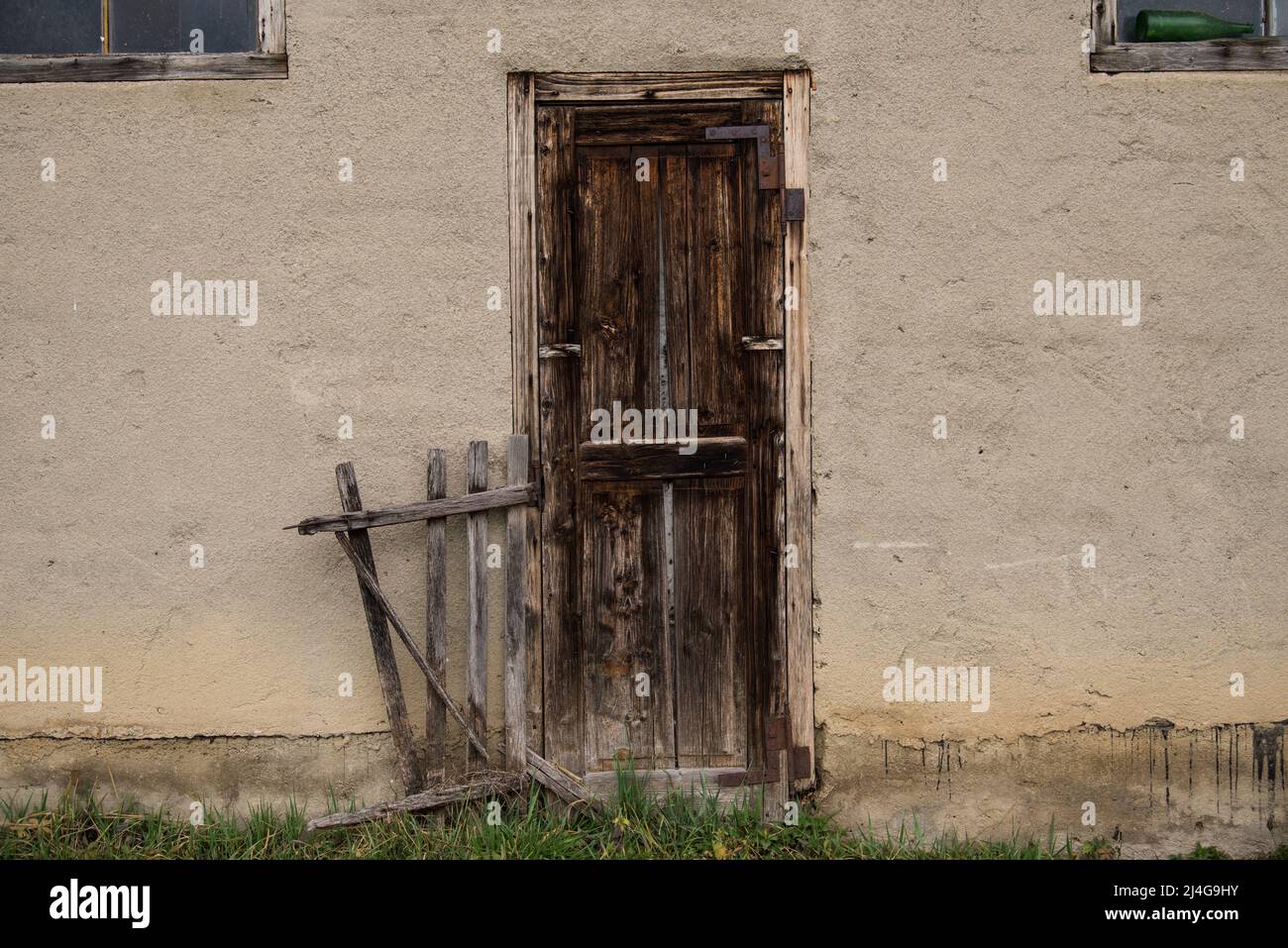 Old wooden rustic doors on rural home wall Stock Photo - Alamy