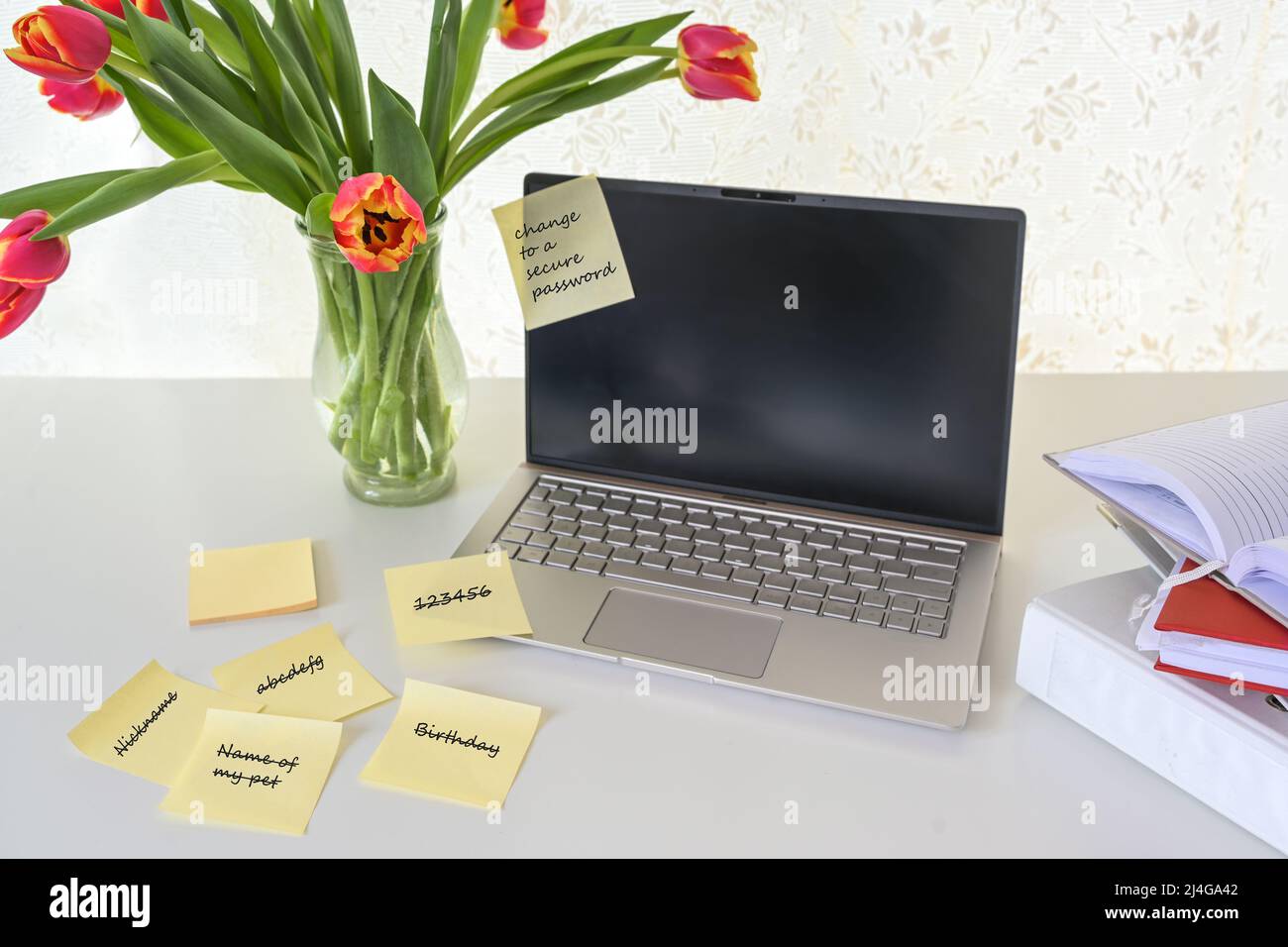 Computer security, laptop with various sticky password notes on a white ...