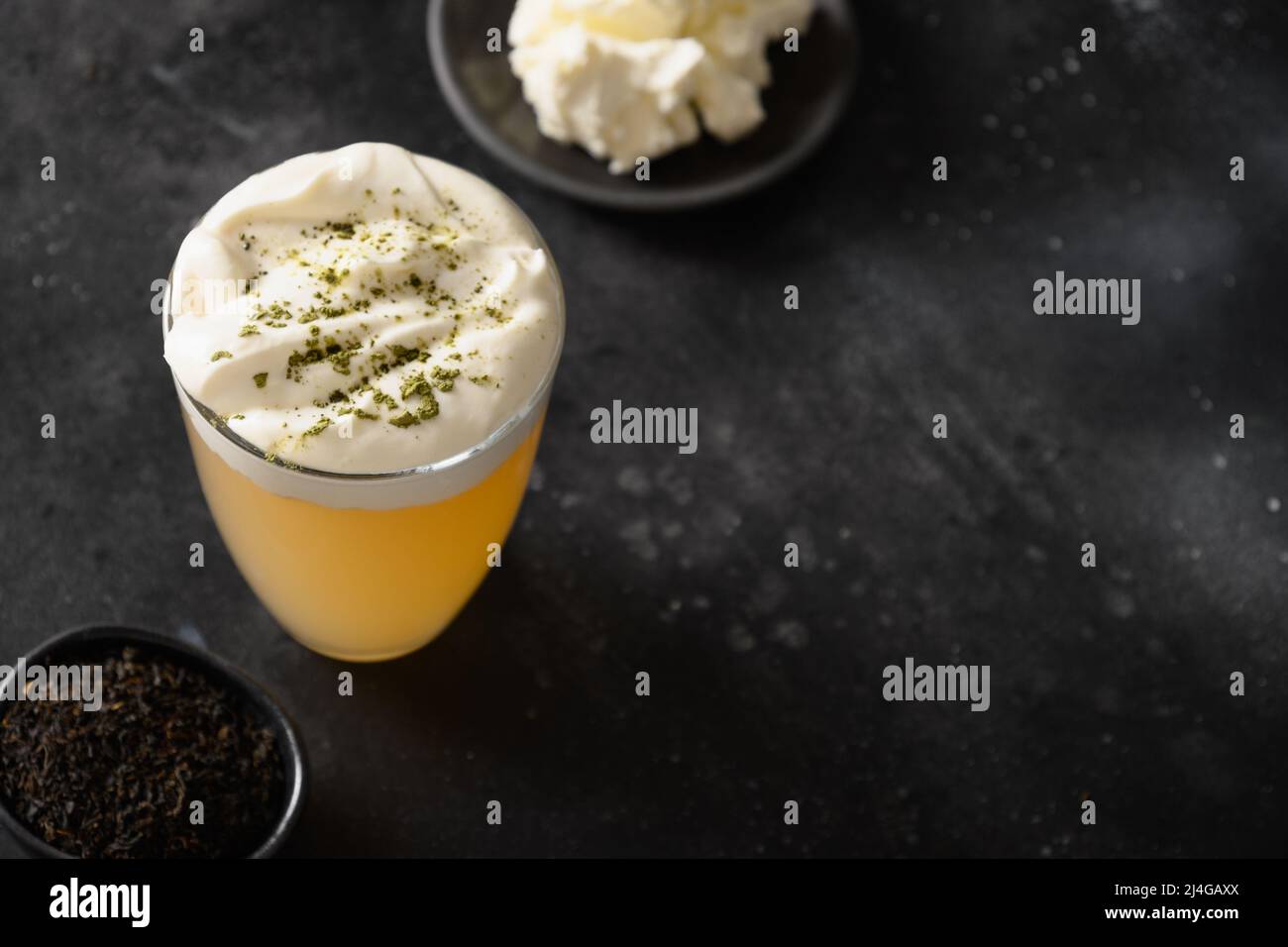 Cheese tea in glass made of green tea with whipped cream cheese on ...