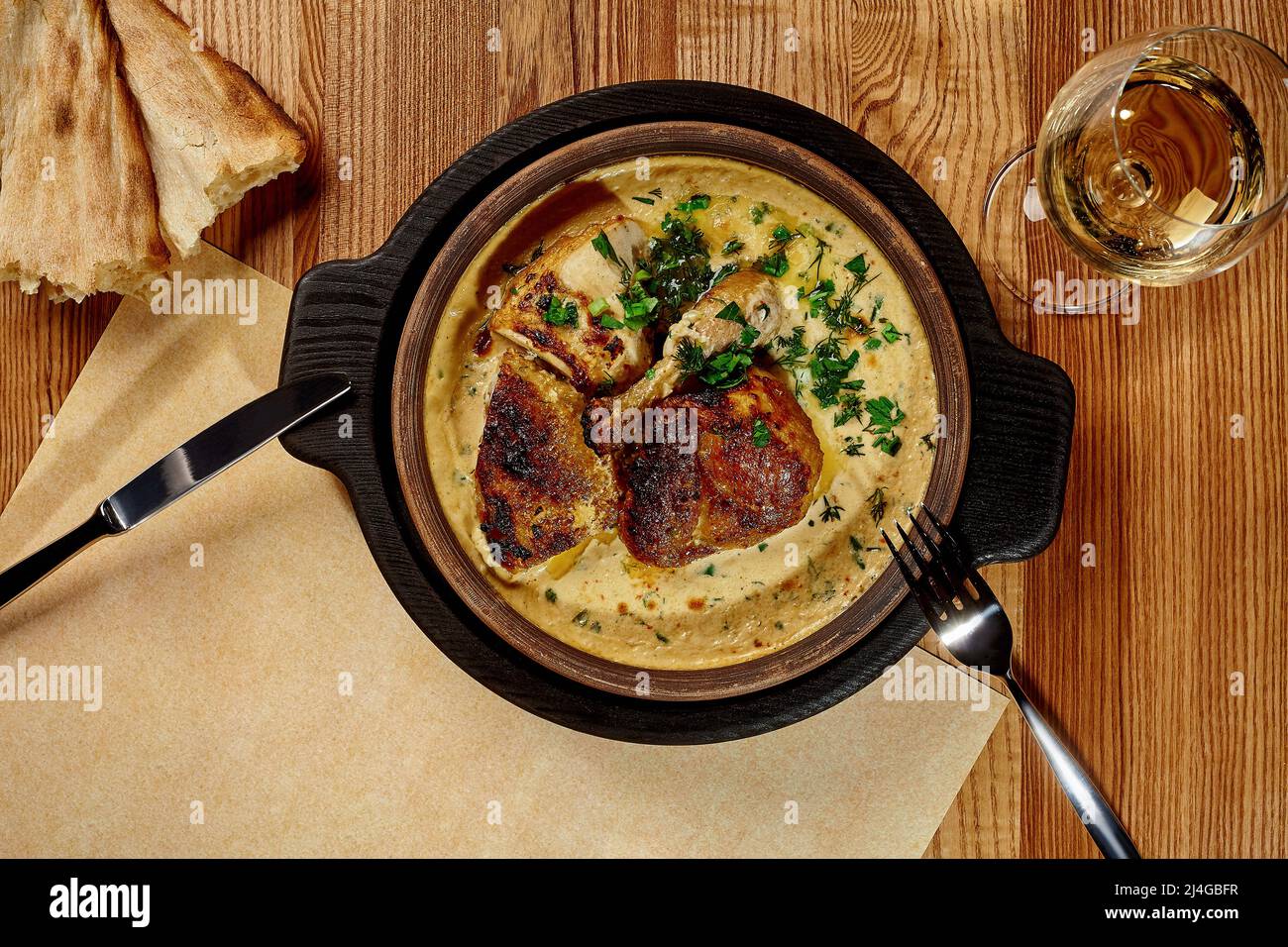 Georgian baked chicken with walnut sauce served in ketsi with shotis ...