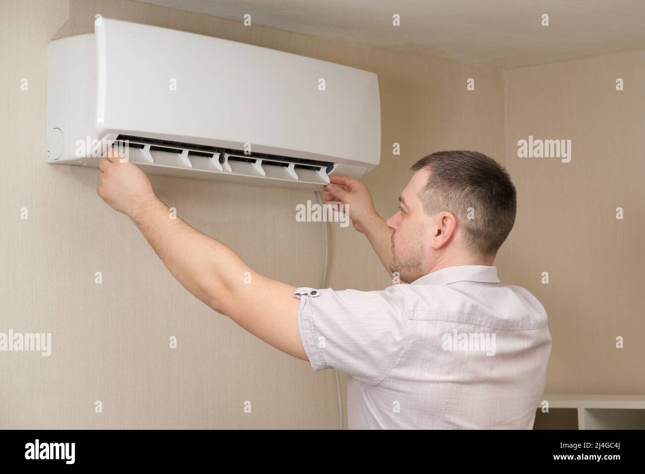 Man with air conditioner hi-res stock photography and images - Alamy