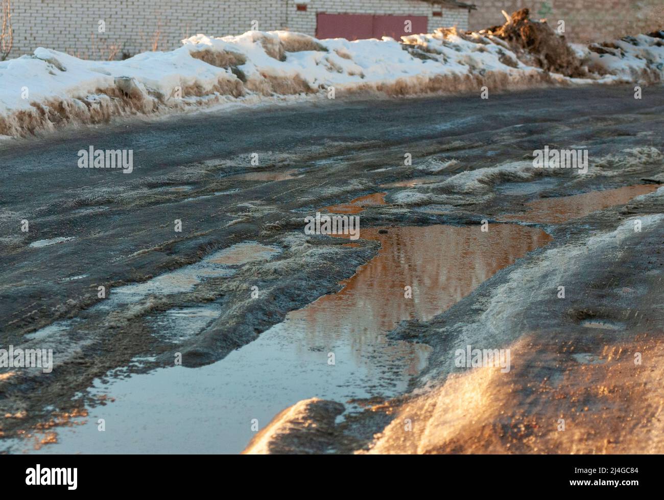 Spring thaw on the road, snow and melting ice Stock Photo - Alamy