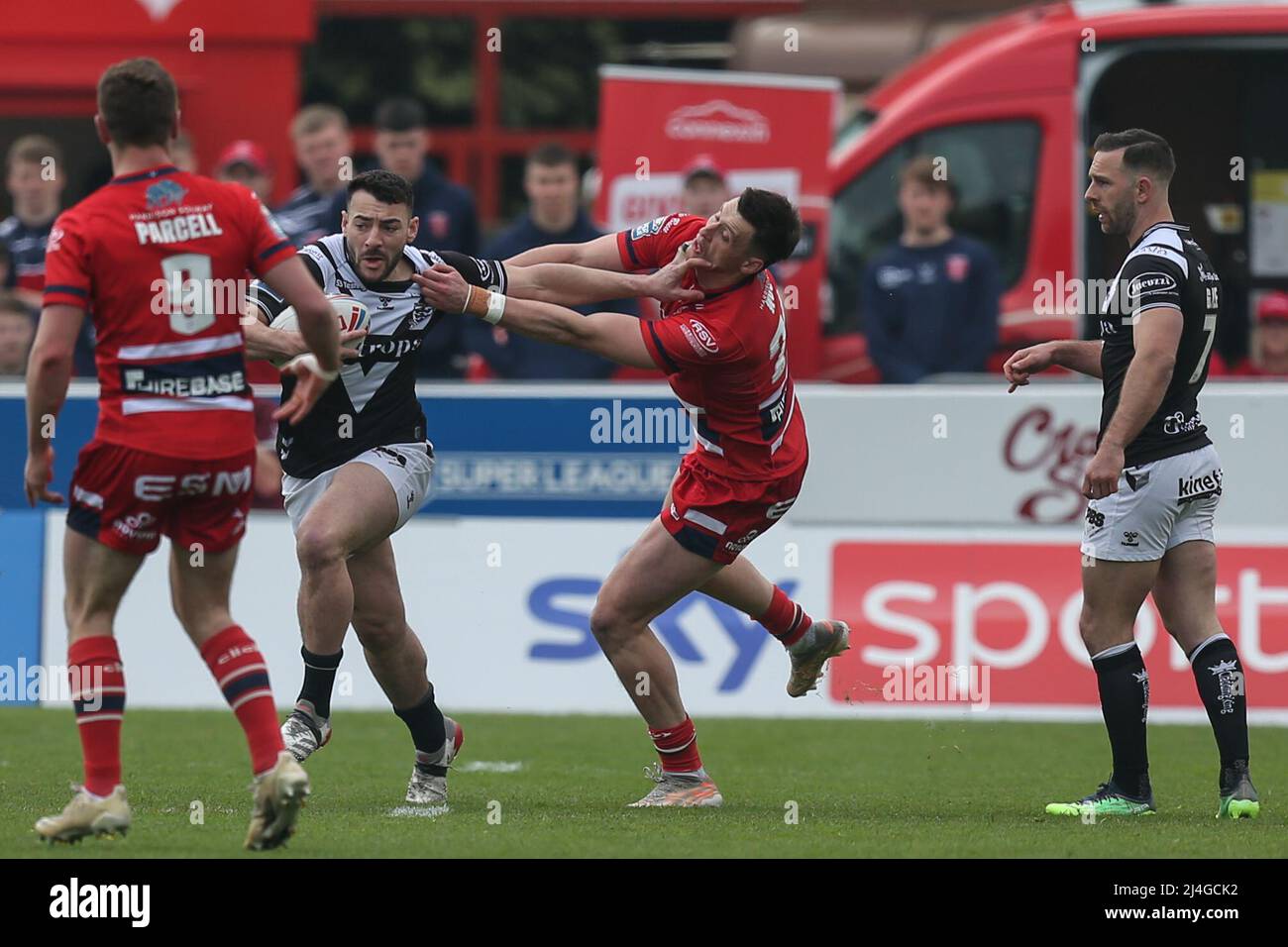 Jake Connor #1 of Hull FC shows a strong arm to Sam Wood #24 of Hull KR ...